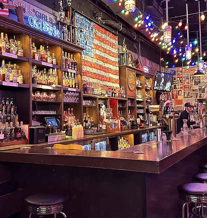 An American flag crafted from beer cans behind the bar? Now that's patriotism you can toast to. The whiskey selection isn't a collection—it's a library.