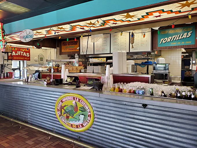 The ordering counter – where Tex-Mex dreams begin their journey from kitchen to table. Note the colorful southwestern star pattern overhead.
