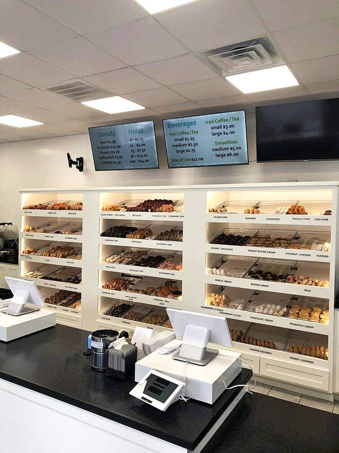 The wall of donuts presents like an art gallery where every piece is edible. Choosing just one feels like Sophie's Choice, but with frosting.