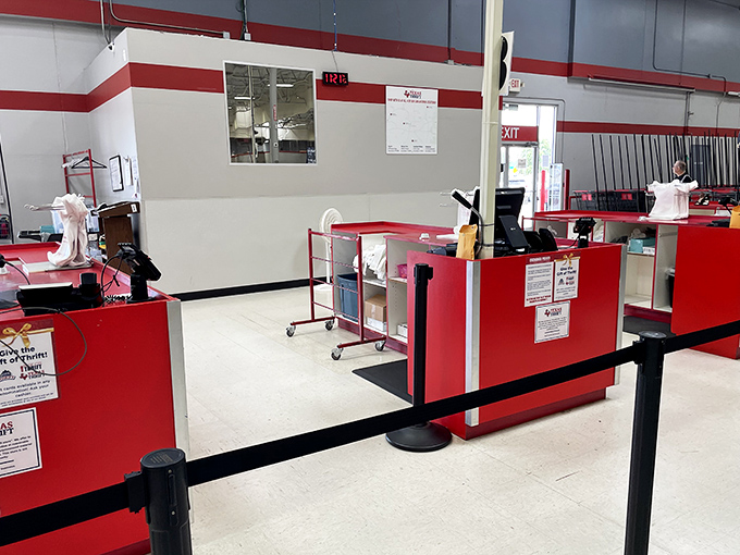 The final frontier: checkout counters where victory is measured in savings. The red barriers contain the excitement of shoppers clutching their finds.