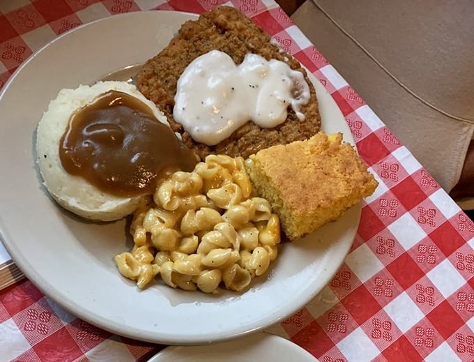 Country fried steak with white gravy, mac and cheese, and cornbread&mdash;a plate that says "you might need a nap afterward" in the most delicious way possible.