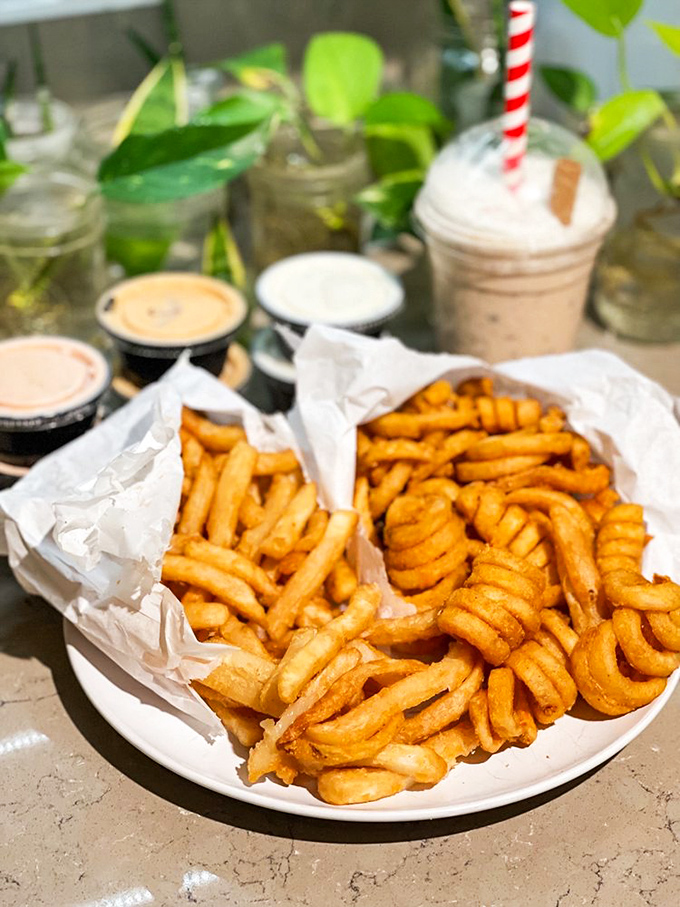 Fries and onion rings presented like treasures in vintage car containers&mdash;because eating from a miniature '57 Chevy somehow makes everything taste better.