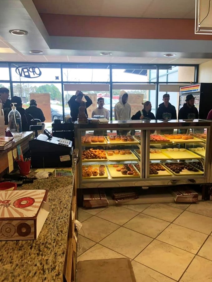 The morning rush at Carolina Glazed is a beautiful dance of anticipation. These customers know that patience yields sweet rewards. 