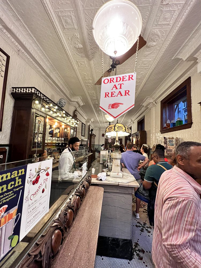 The narrow interior creates a shared experience among strangers. Nothing builds community quite like collective anticipation of impending ice cream bliss.