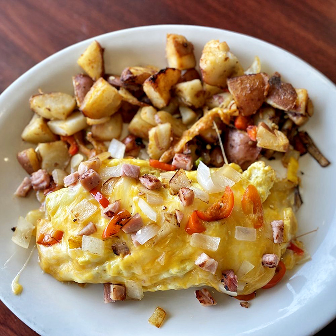 This isn't just any omelet—it's a Denver skyline of flavors with ham, peppers, and cheese melting into eggy perfection.