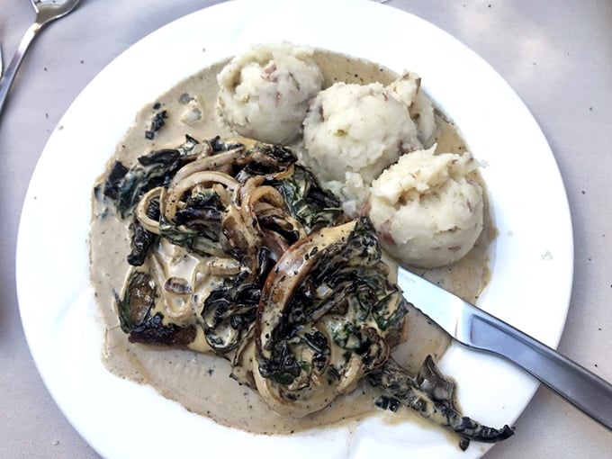 Dark greens swimming in cream sauce alongside perfect potato dumplings&mdash;a dish that makes you forget you're eating in a former financial institution.