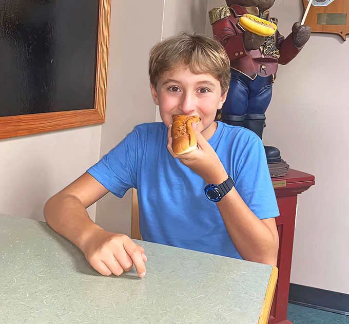The sign says "Please Stand in Line" because good things come to those who wait, especially when those good things are legendary hot dogs.