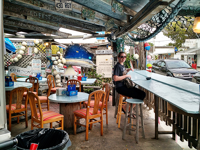 Nautical whimsy meets practical dining. Fishing nets overhead, mismatched chairs below&mdash;this isn't decoration, it's authentic Keys character.