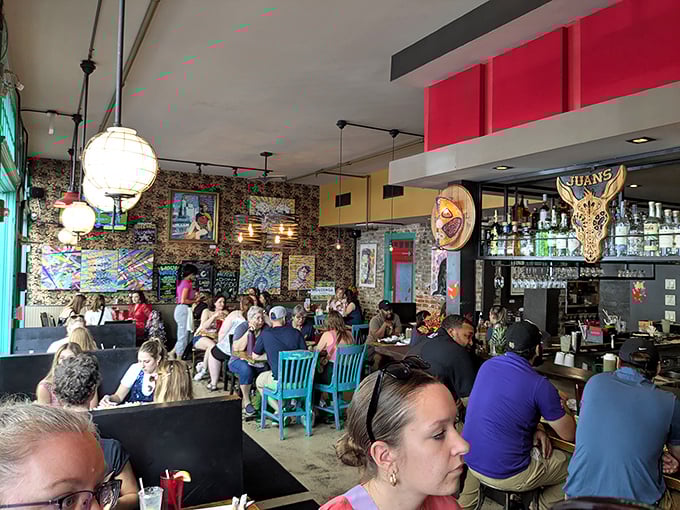 A bustling dining room where strangers become temporary family, united by the universal language of "Oh my god, you have to try this."