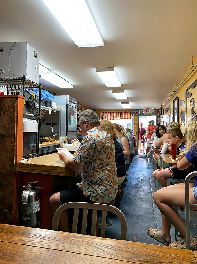Where strangers become friends over scrambled eggs. The narrow dining space creates a cozy community of breakfast enthusiasts sharing the experience.