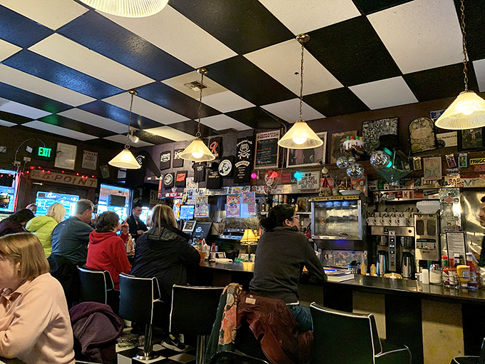 Under the iconic checkerboard ceiling, strangers become neighbors at the counter, united by coffee and the pursuit of comfort food.