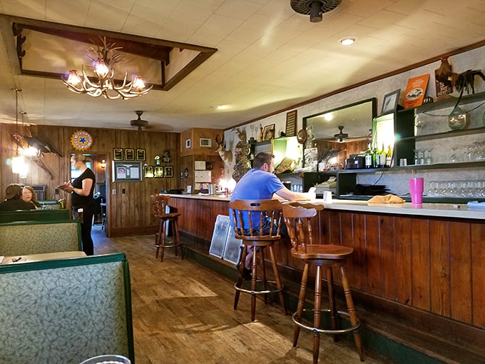 Where rustic meets refined &ndash; wooden paneling and green booths create the perfect backdrop for conversations that last longer than the food.