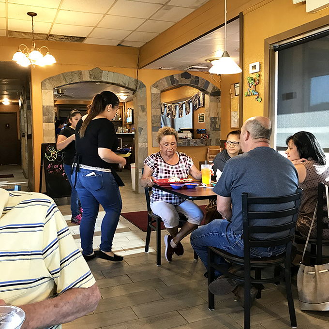 Every table tells a story of families gathering, conversations flowing, and plates being passed. The true magic of Taqueria Arandas happens right here.