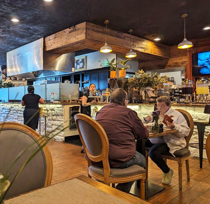 The open kitchen design isn't just practical&mdash;it's dinner and a show where every table feels like the chef's table.