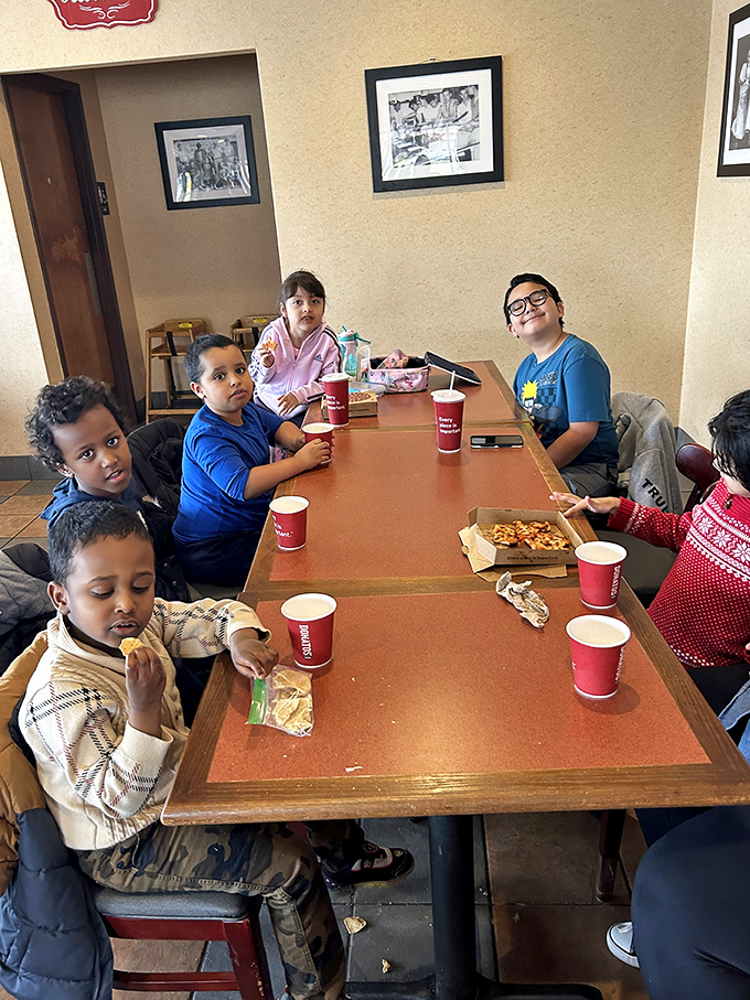 These young diners represent the next generation of Pizza House enthusiasts, creating memories one bite at a time around a table of tradition.