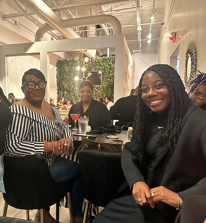 Happy diners experiencing what philosophers call "seafood bliss." That smile says everything about the Baltimore Crab & Seafood experience.