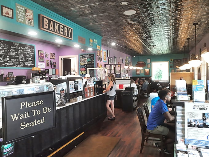 The bustling counter area where pastry dreams come true. That chalkboard menu is like a roadmap to happiness.