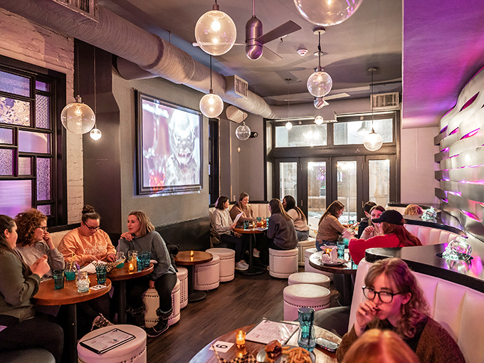 Movie night meets dinner service as horror films play in the background. These diners are too busy enjoying their meals to notice any on-screen screams.