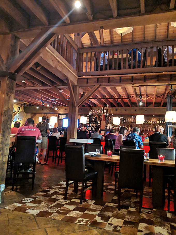 The multi-level dining space preserves the barn's original character. Diners enjoy intimate conversations while soaking in the architectural details of this 1850s structure
