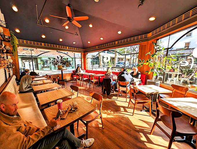 Sunlight streams through windows, painting diners in golden light as they enjoy their morning ritual. Some read, some chat, all participate in the universal ceremony of good food.