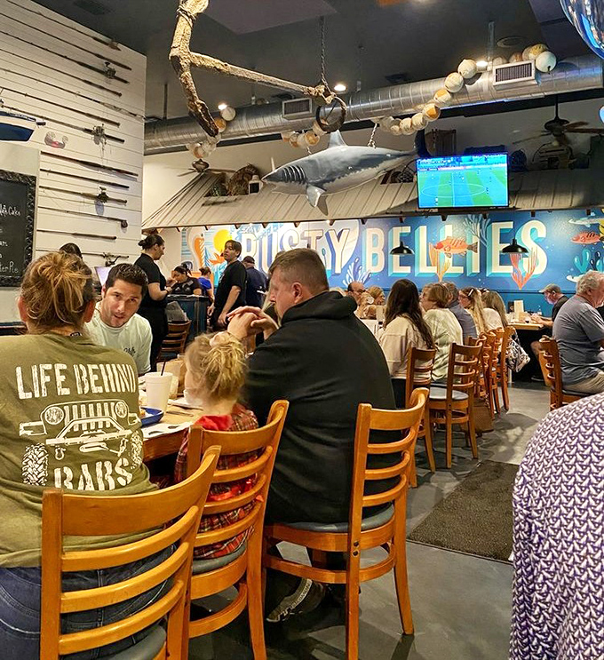 Where families gather to create memories seasoned with salt air. That shark overhead isn't just decoration&mdash;it's keeping an eye on portion control.