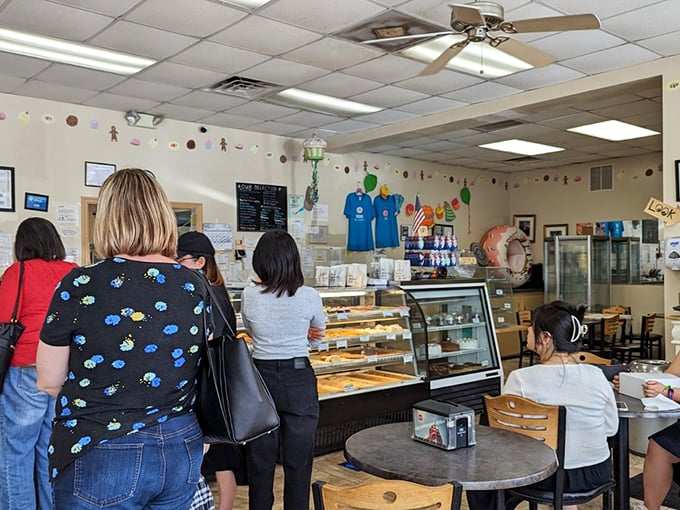 The universal language of anticipation. These customers know that patience isn't just a virtue&mdash;it's the price you pay for pastry perfection.