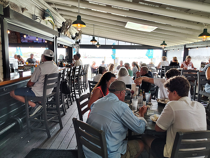 Where strangers become friends over grouper. The outdoor dining area buzzes with conversation as diners bond over the universal language of fresh seafood.
