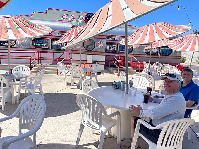 Outdoor patio dining under cheerful umbrellas - because sometimes breakfast tastes better with a side of sunshine.