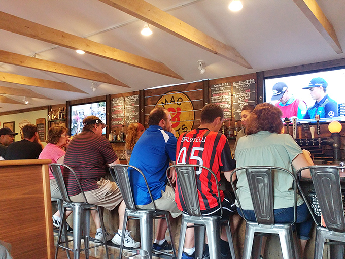 The bar scene at Mac & Walt's&mdash;where sports jerseys meet craft beer enthusiasm and nobody judges your third helping of cheese-covered pasta.