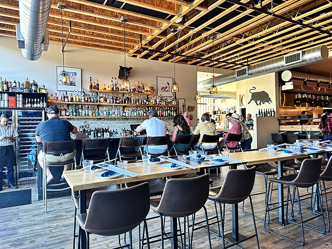 Diners enjoying the open kitchen concept where culinary theater unfolds before your very eyes nightly.