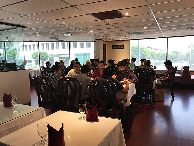The universal language of good food brings diners together. Notice the absence of phones&mdash;everyone's too busy experiencing actual reality.