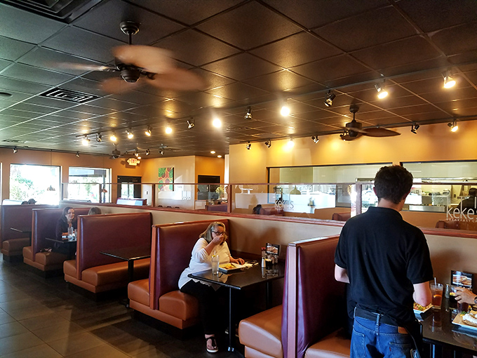 The breakfast buzz in full swing—where strangers become temporary neighbors united by the universal language of "pass the syrup."