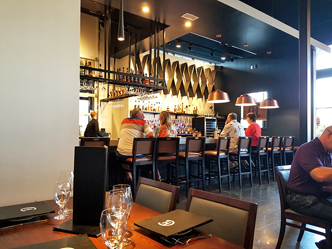 The bar area buzzes with the energy of people who know they've found something special. Those copper pendant lights cast the perfect glow for decision-making.