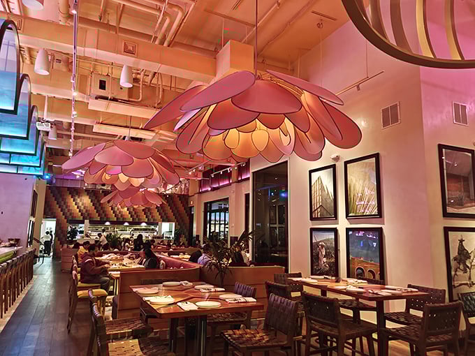 Under the glow of pink petal chandeliers, every table becomes the best seat in the house. Even the ceiling is dressed to impress.