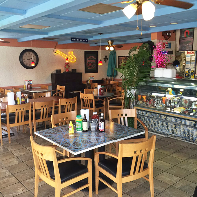 Mosaic-topped tables, wooden chairs, and tropical plants create an atmosphere where time slows down and conversations flow as easily as the bourbon sauce. 