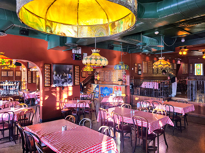Red-checkered tablecloths and vintage lighting create the perfect nostalgic atmosphere. This dining room has hosted generations of Toledo families.