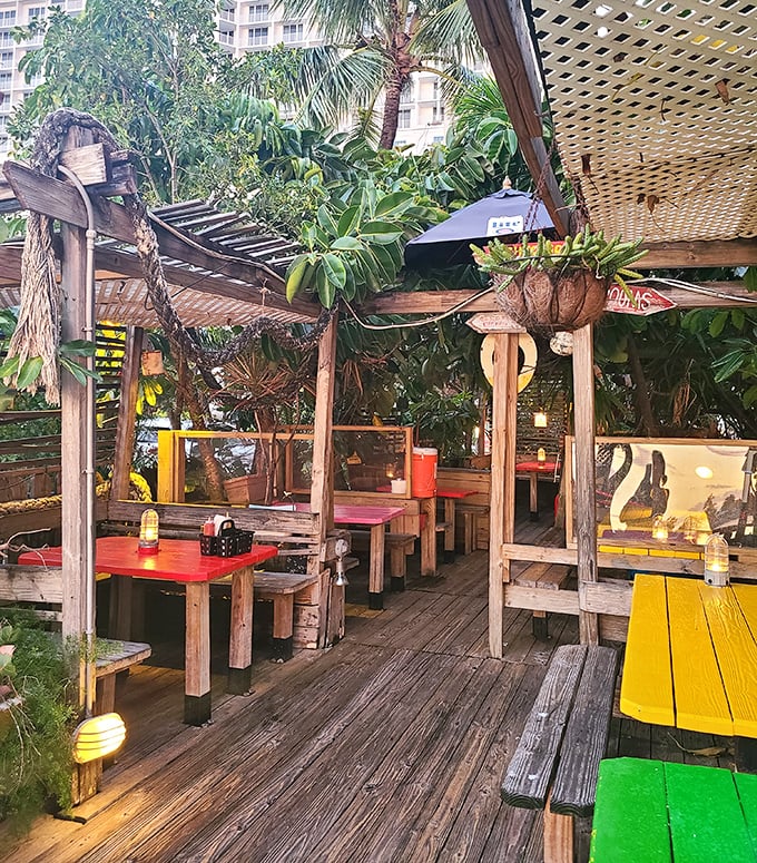 Weathered wood, colorful tables, and dappled sunlight create the laid-back dining atmosphere that makes you want to linger over lunch well into dinner.