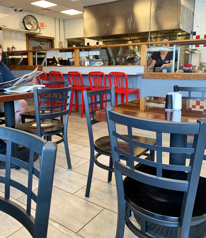 Blue chairs invite you to stay awhile, while red counter stools suggest you might want to hurry up &ndash; the perfect dining contradiction.