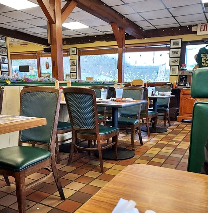 The dining area's wooden beams and green chairs create that perfect small-town atmosphere where breakfast conversations become the highlight of your day.