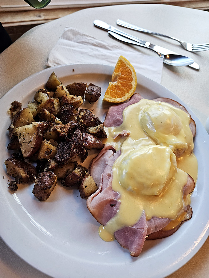 Eggs Benedict done right&mdash;poached to runny perfection, draped in hollandaise that's clearly homemade, with potatoes that didn't come from a freezer bag.