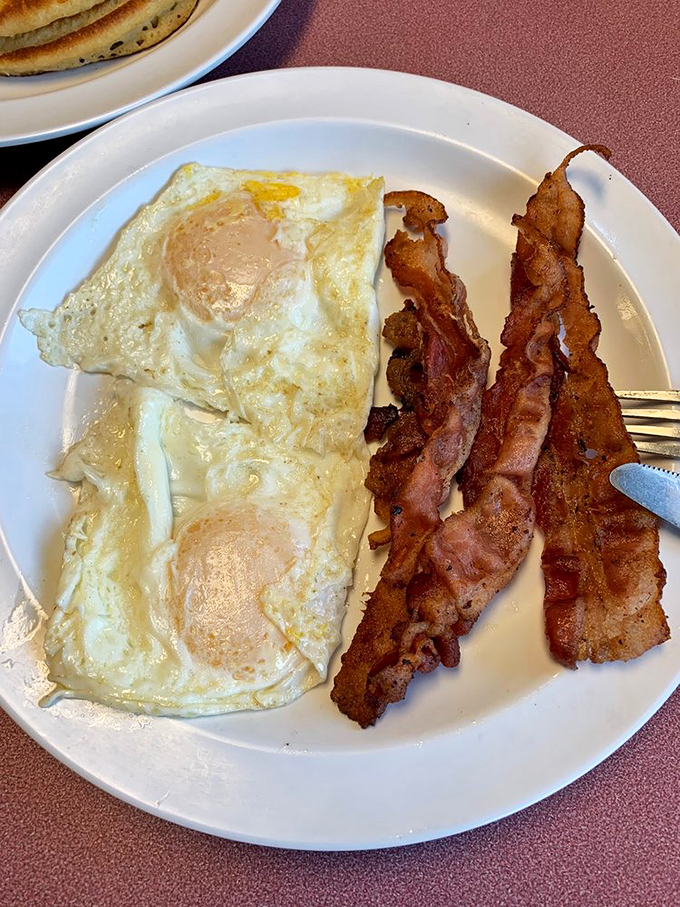 Eggs sunny-side up with perfectly crisped bacon&mdash;breakfast's dynamic duo. Simple, honest food that reminds you why classics never go out of style.