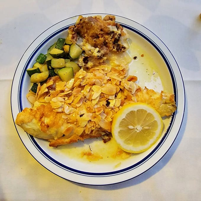 Fish that wears its almond armor with pride. The lemon stands ready to cut through richness with citrus brightness.