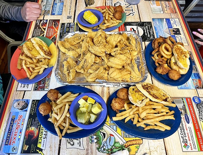 A seafood feast spread across the table like a fisherman's holiday. The newspaper placemats aren't just practical&mdash;they're part of the authentic experience.