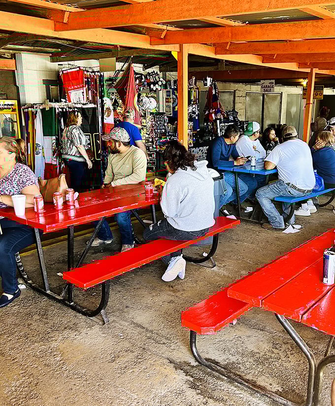 The social heart of the market&mdash;red picnic tables where strangers become friends over cold drinks and flea market finds.