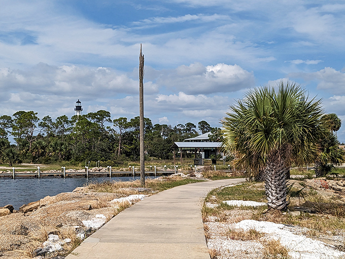 The waterfront walkway invites leisurely strolls with the lighthouse standing sentinel in the distance. Every step offers a new perspective.