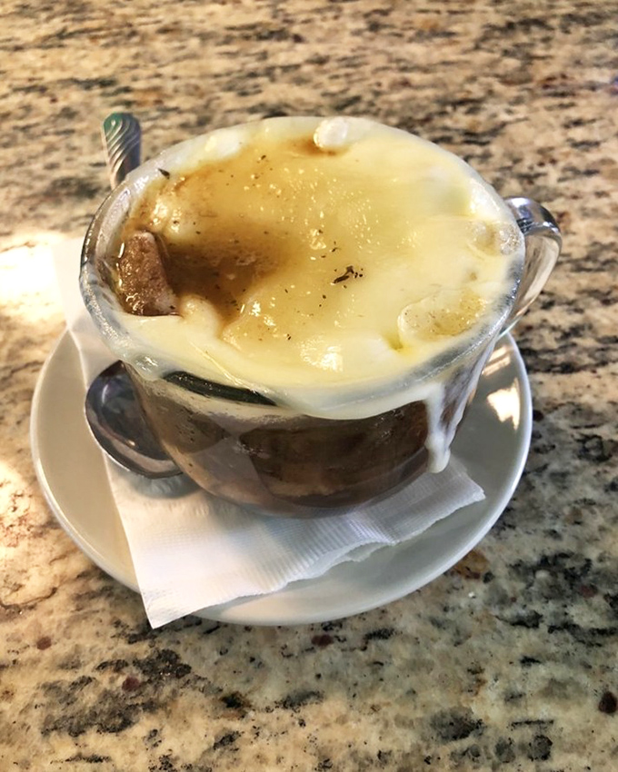 French onion soup that's wearing a melted cheese hat and isn't afraid to show it. Comfort in a crock that's worth the inevitable shirt stain.