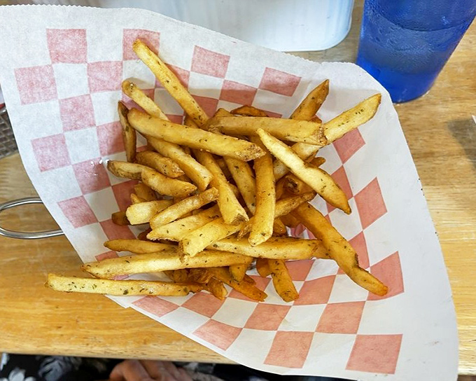 Fries that achieve that mythical balance&mdash;crispy exterior, fluffy interior. The red-checkered paper is just showing off at this point.