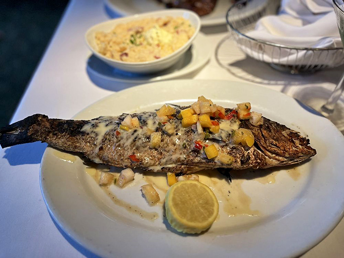 This whole snapper looks like it swam directly from ocean to fire to plate, wearing its citrus-butter sauce like a delicious designer outfit.