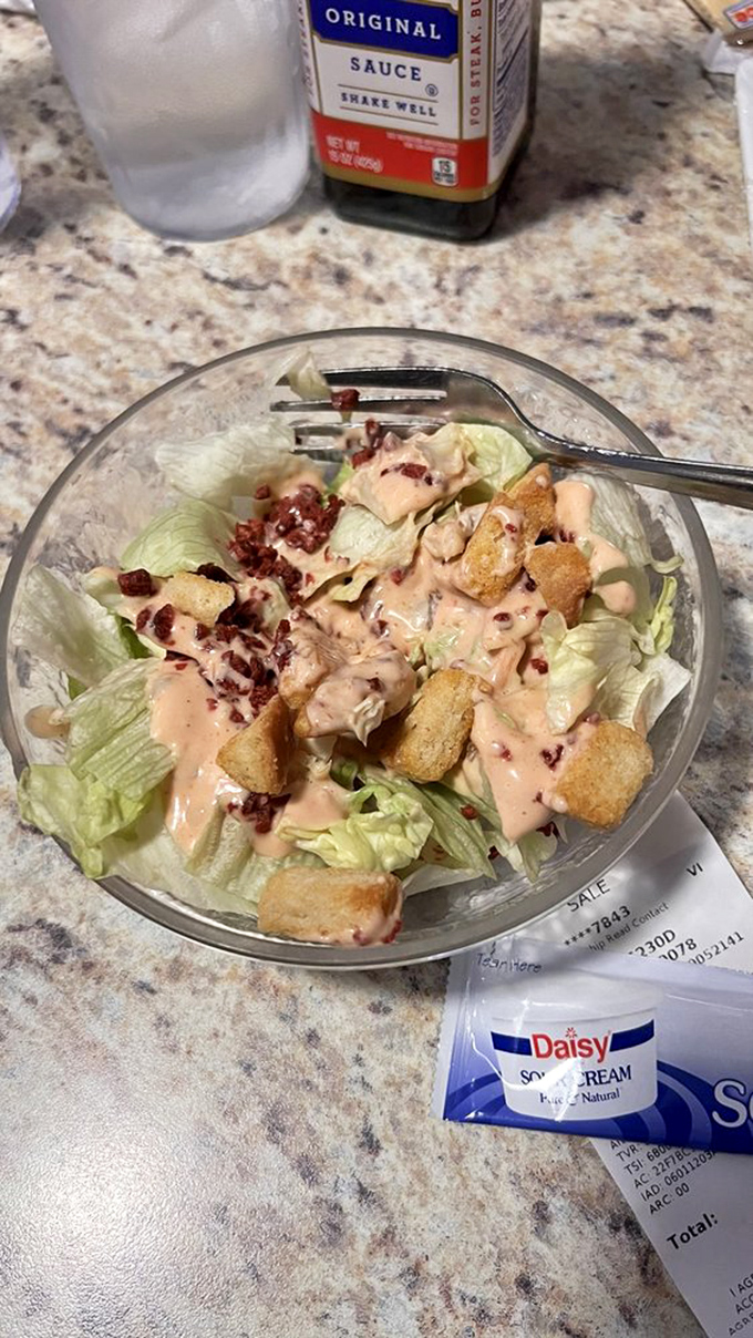 A simple side salad elevated by thousand island dressing and bacon bits &ndash; proving that even the supporting players deserve their moment in the spotlight.