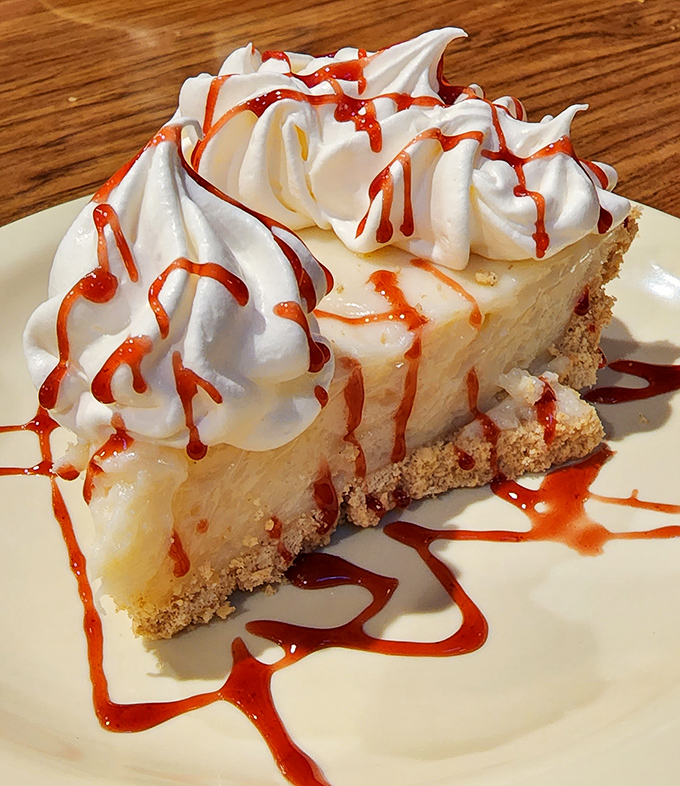 Key lime pie with whipped cream and raspberry drizzle&mdash;proof that sometimes the best things in life come on small plates with big flavors.
